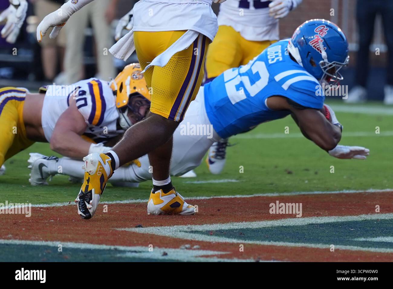 Mississippi running back Logan Diggs (22) stretches past LSU linebacker ...