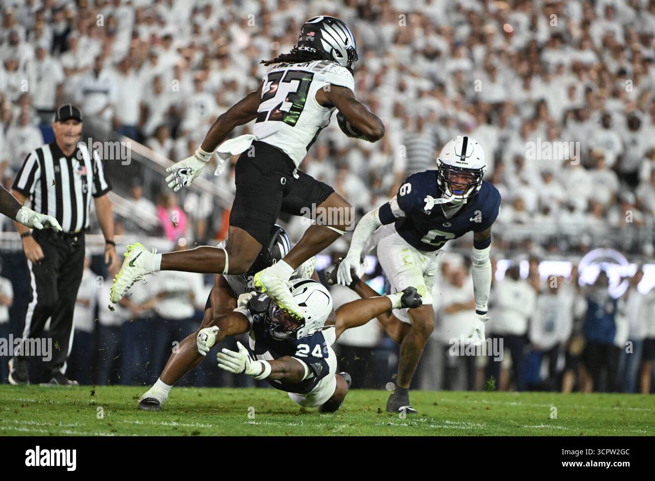 Oregon running back Dierre Hill Jr. (23) hurdles Penn State linebacker ...