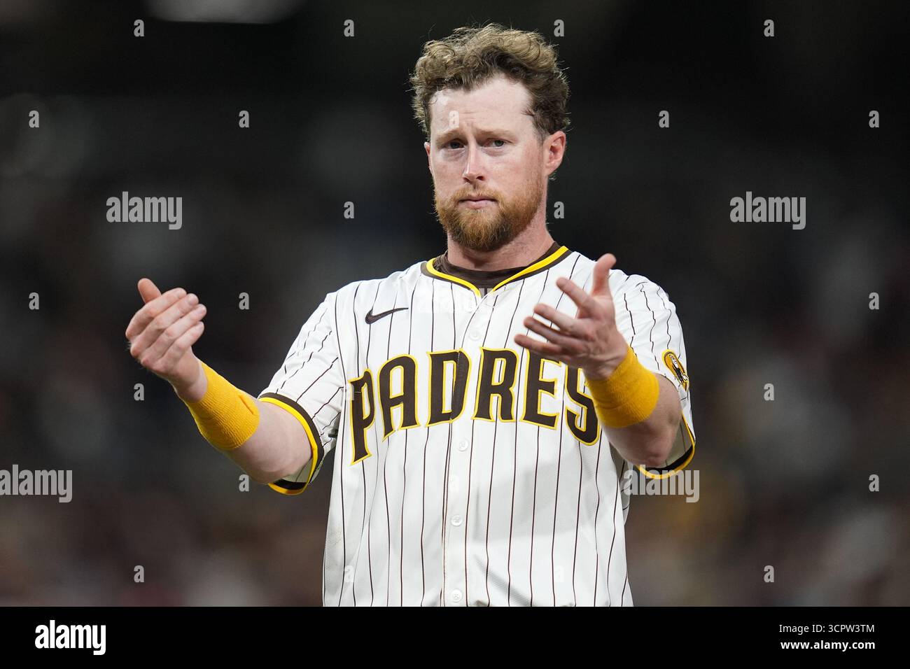San Diego Padres second baseman Jake Cronenworth jokes with a teammate ...