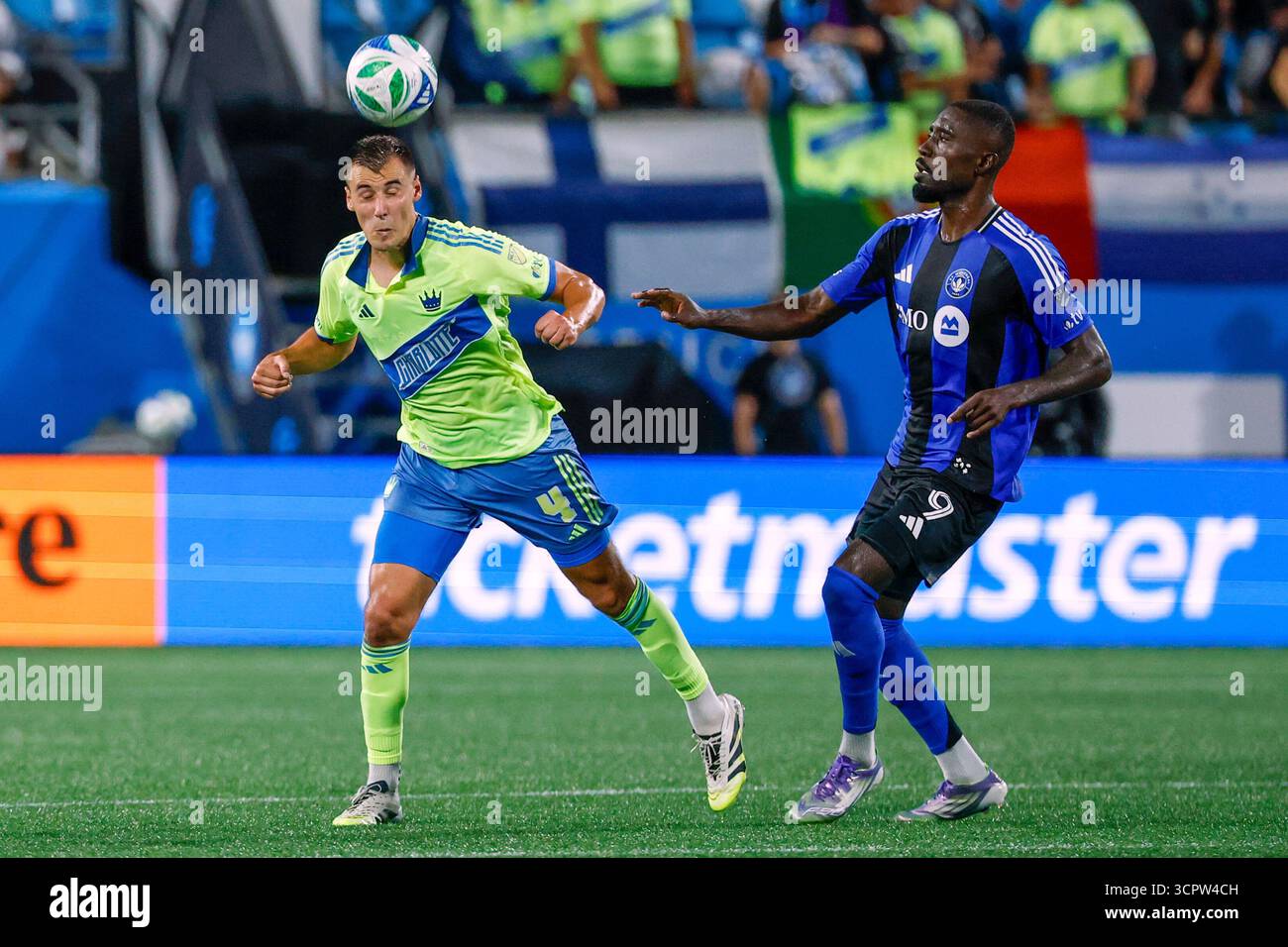 Charlotte FC midfielder Andrew Privett (4) heads the ball against CF ...