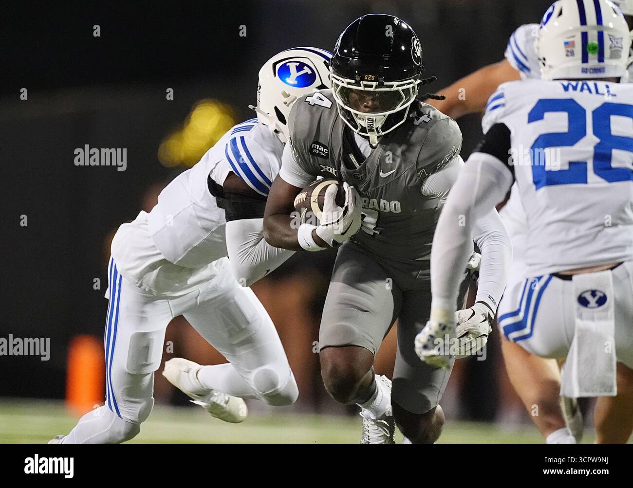 Colorado wide receiver Omarion Miller, center, runs for a short gain ...