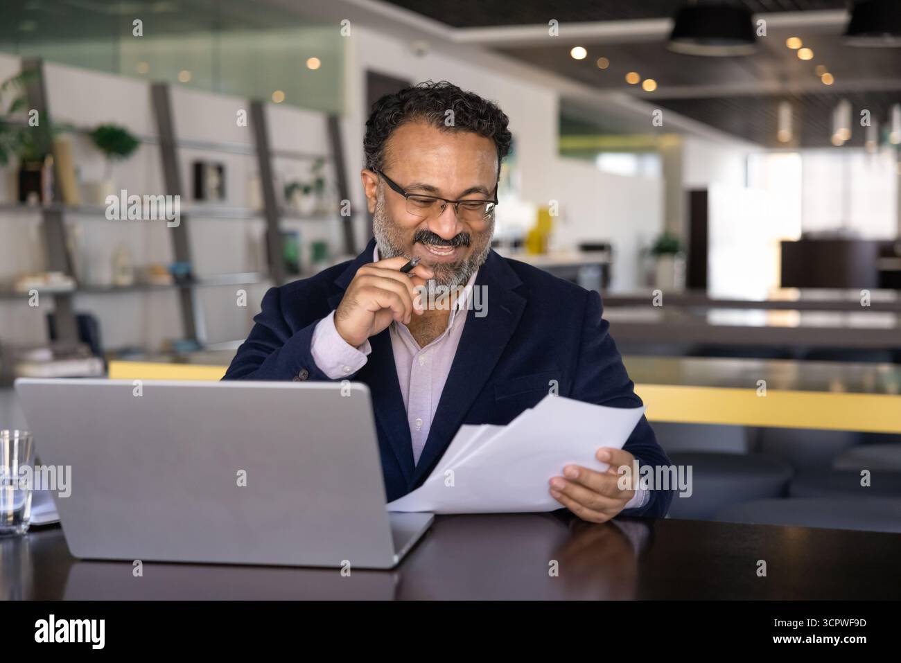Indian man reviewing documents hi-res stock photography and images - Alamy