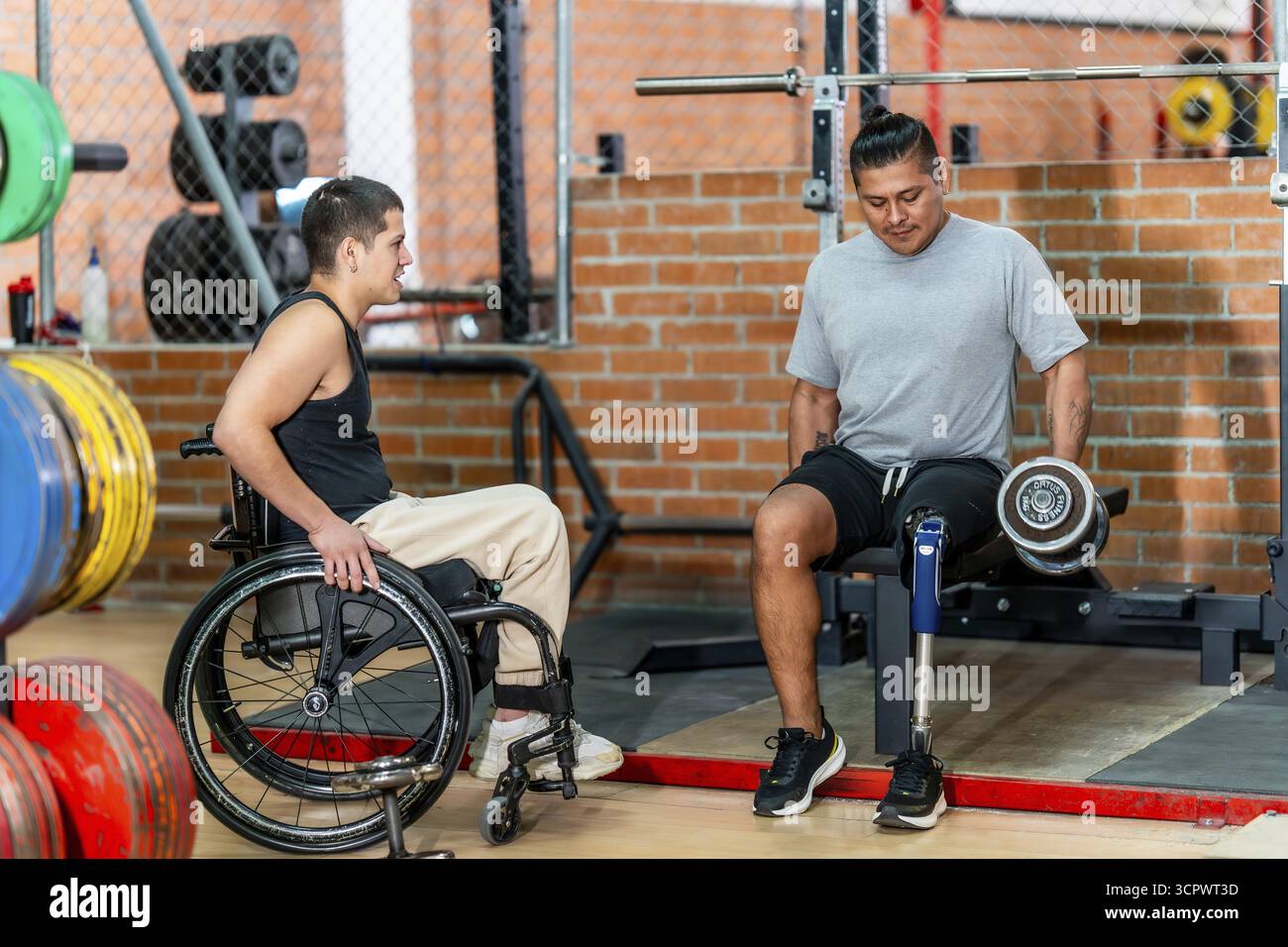 Two men with disabilities, one using a wheelchair and another with a ...