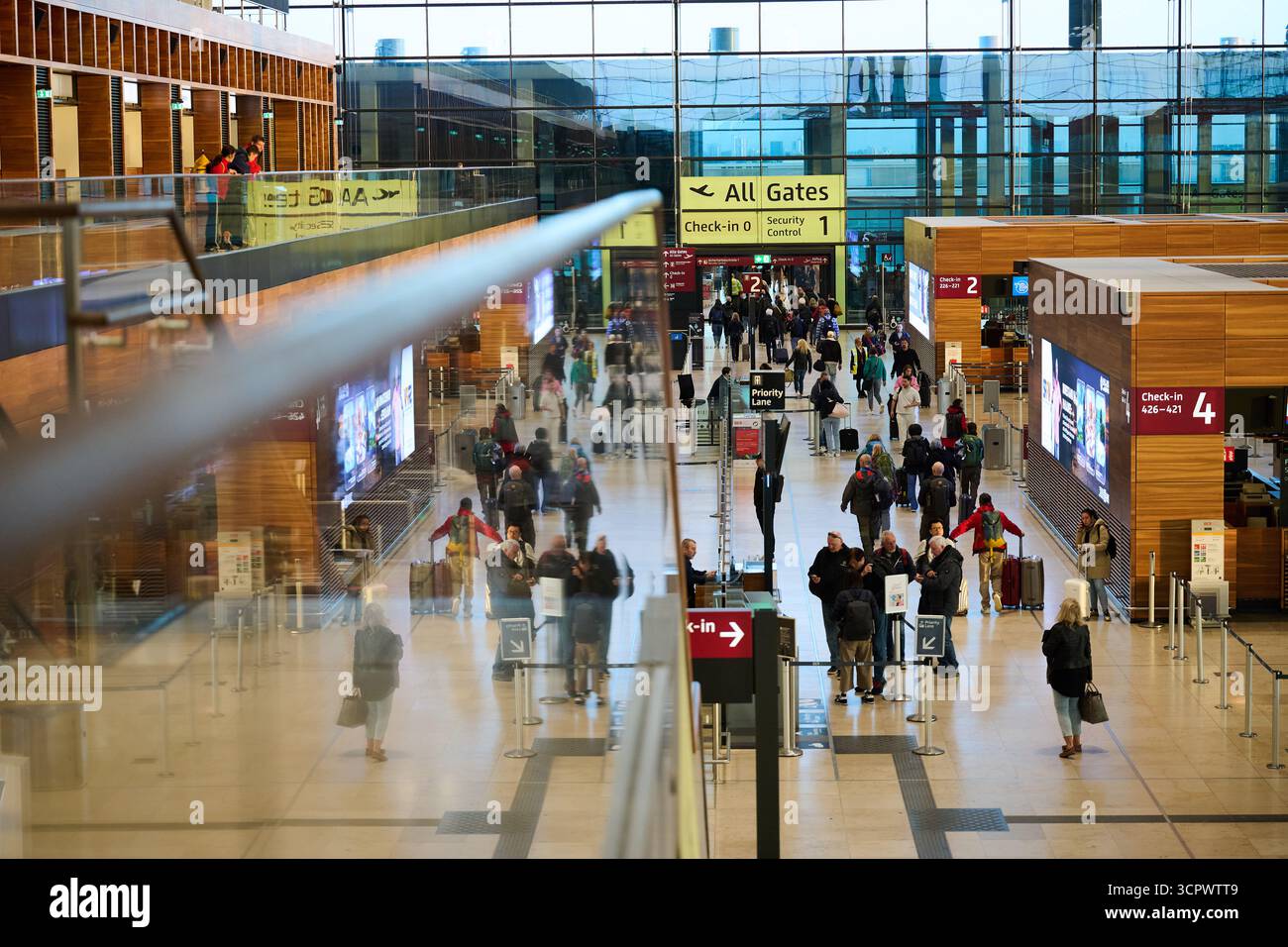 28 September 2025, Brandenburg, Schönefeld: People go through security at BER Airport. The ...