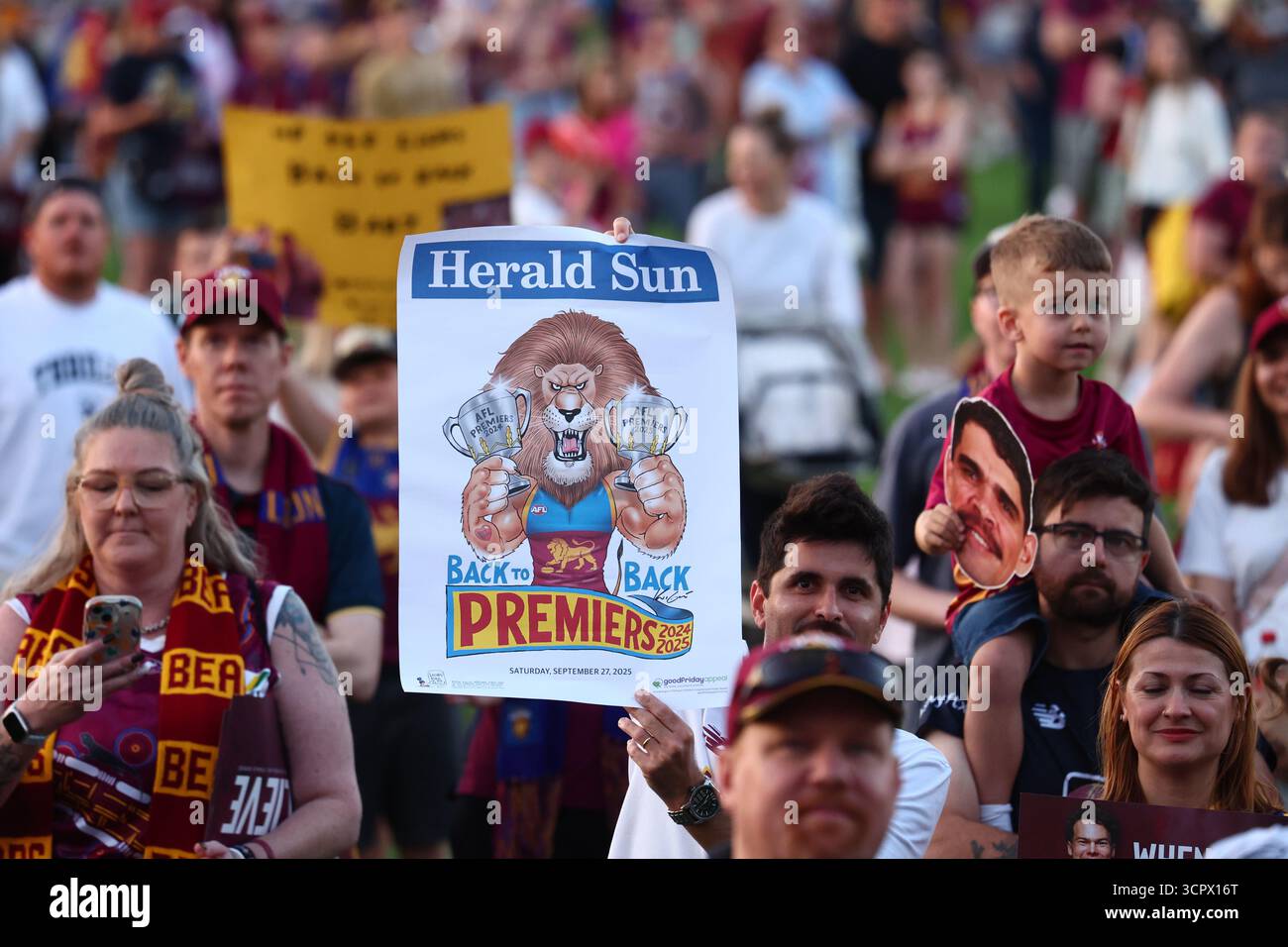 Lions fans celebrate winning the AFL Premiership at Springfield Central ...