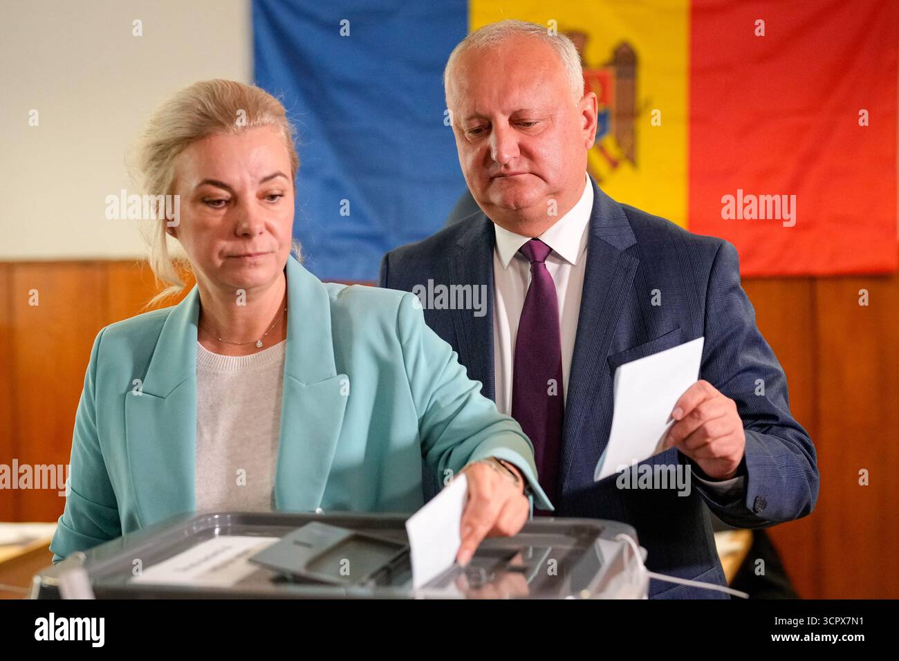 Former Moldovan President Igor Dodon and his wife Galina cast their ...
