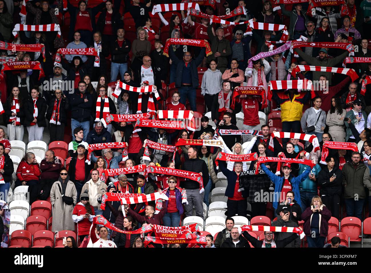 Liverpool fans hold up scarfs while singing 'You'll Never Walk Alone ...