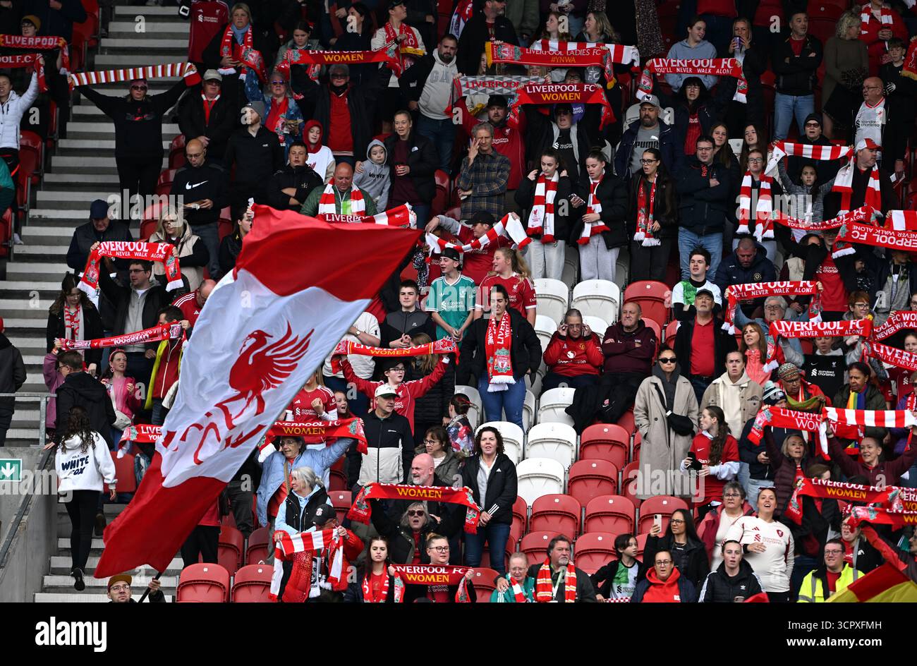 Liverpool fans hold up scarfs while singing 'You'll Never Walk Alone ...