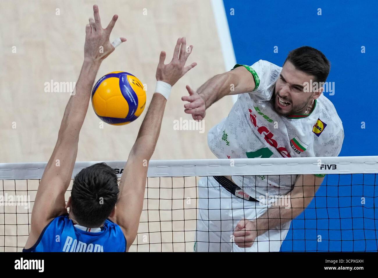 Martin Atanasov of Bulgaria, right, spikes against Yuri Romano of Italy ...