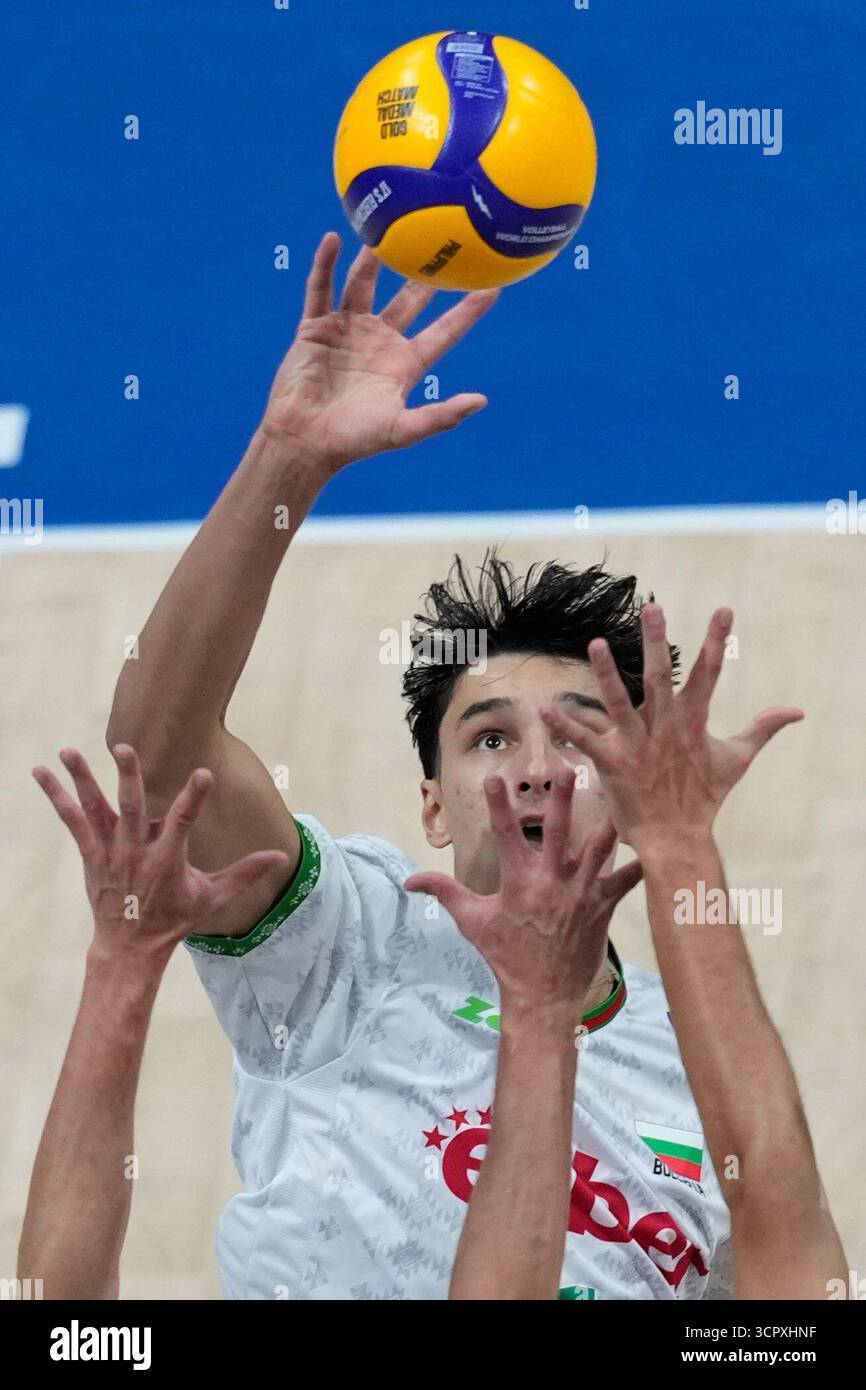 Simeon Nikolov of Bulgaria spikes against Mattia Bottolo and Roberto Russo of Italy during the ...