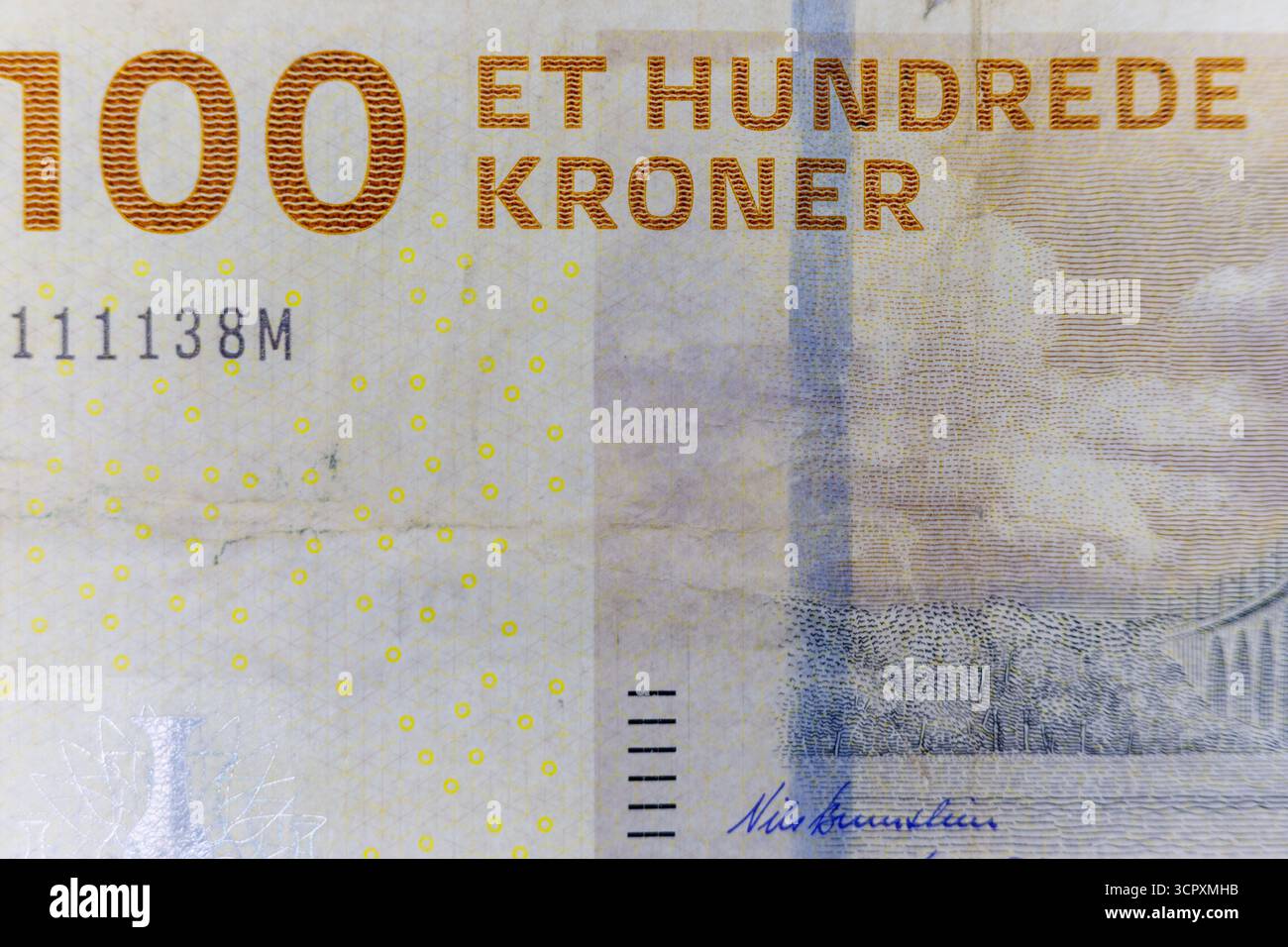 Close-up of a 100 Danish Kroner banknote showing the numerical value ...