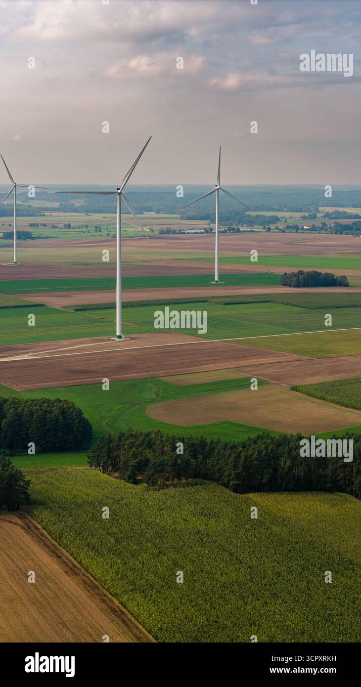 Scenic aerial view of wind turbines in a rural landscape with green and ...