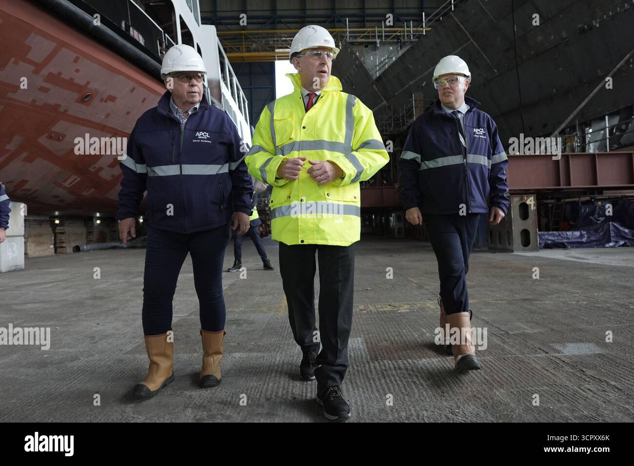 Defence Secretary John Healey (centre) speaks to members of staff in ...