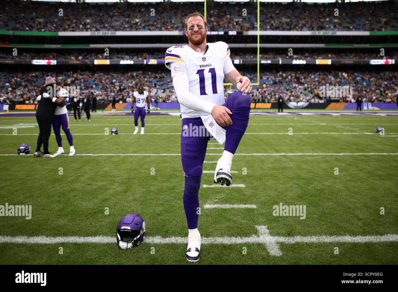 Minnesota Vikings quarterback Carson Wentz (11) stretches to warm up ...
