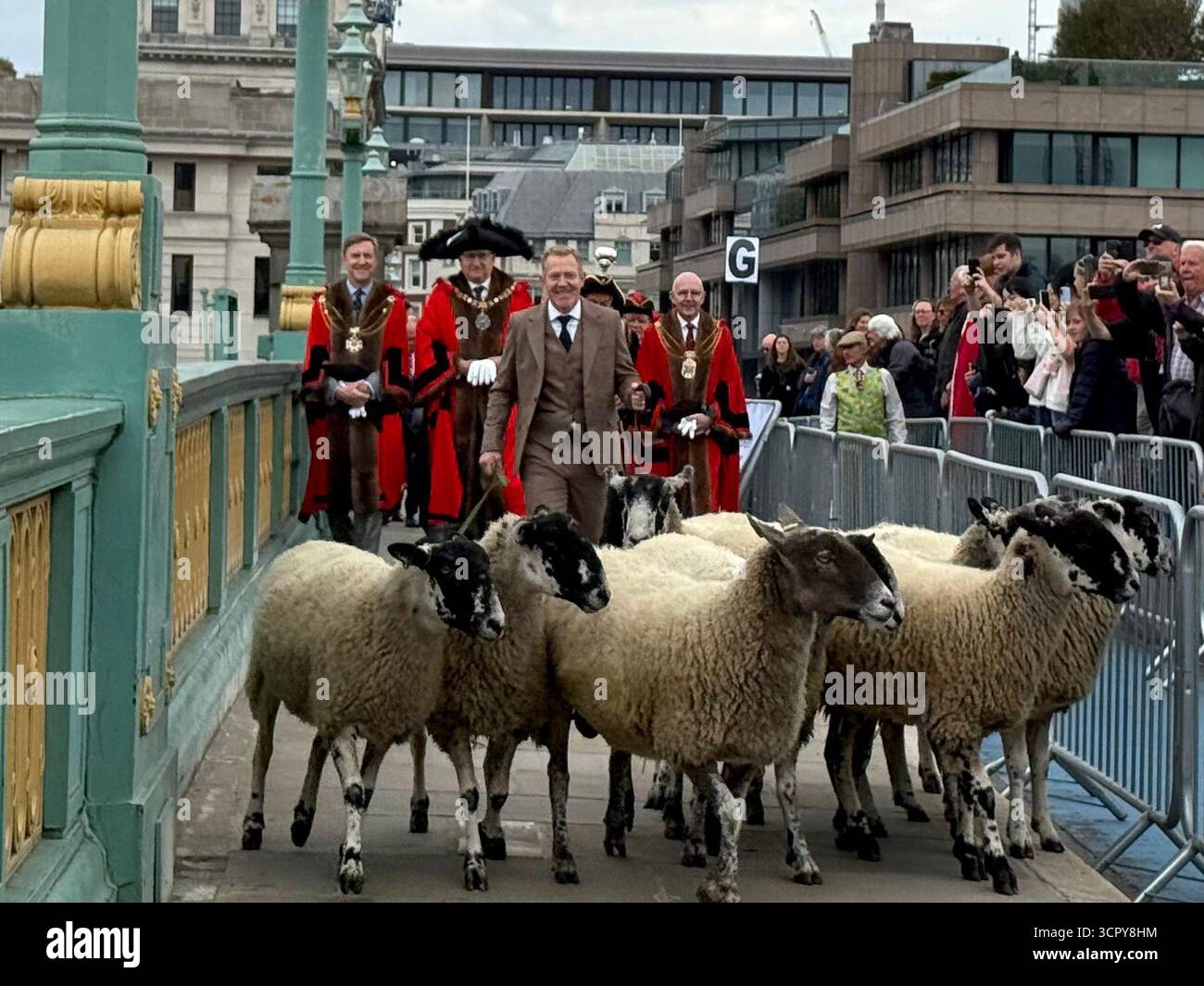 Farmer and broadcaster Adam Henson (centre) drives sheep over Southwark ...