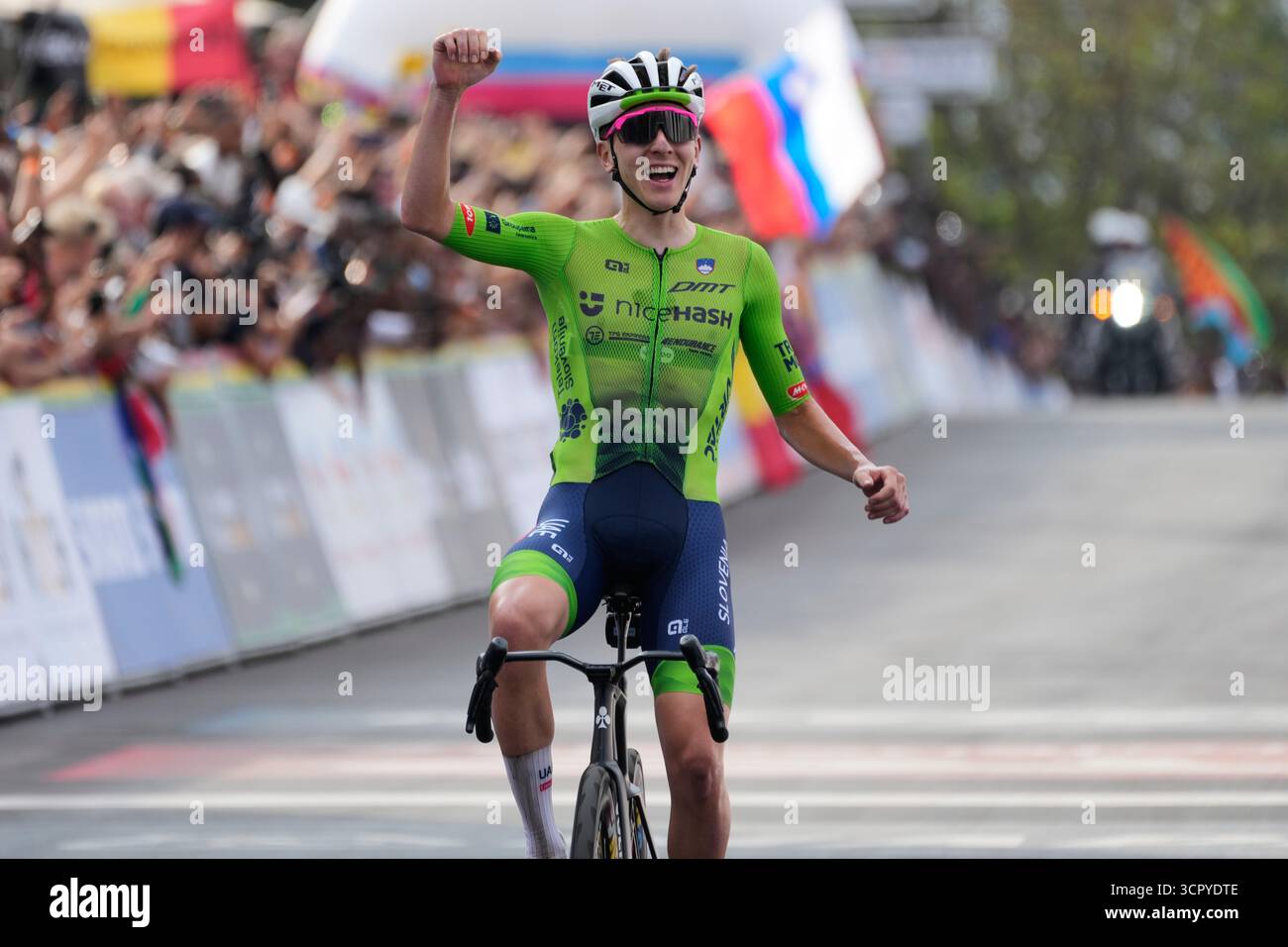 Slovenia's Tadej Pogacar celebrates winning the men's Elite road race ...