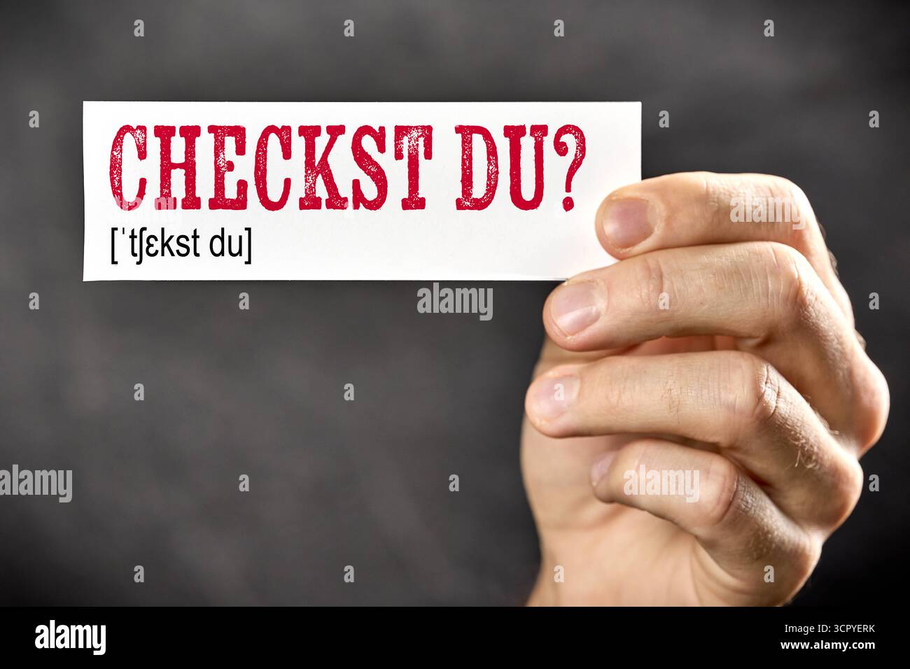 Germany - September 27, 2025: PHOTO MONTAGE, The youth word Checkst du is shown on a card with ...