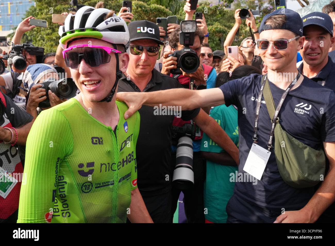 Slovenia's Tadej Pogacar smiles after winning the men's Elite road race ...