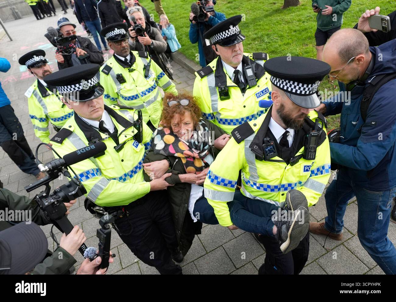 A protestor is carried away by police at a Palestine Action ...