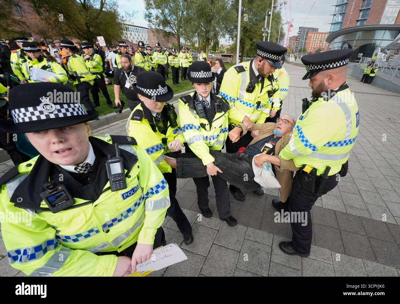 A protestor is carried away by police at a Palestine Action ...