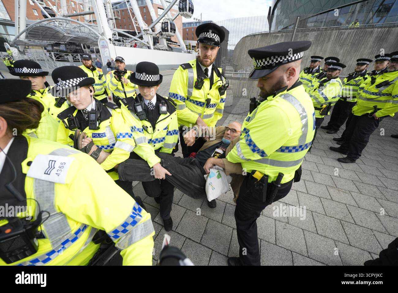 A protestor is carried away by police at a Palestine Action ...