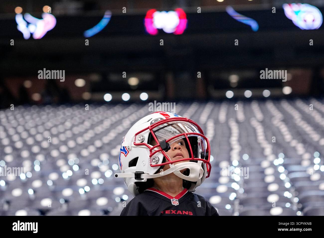 Blaz Lopez, 5, looks onto the field before an NFL football game between ...