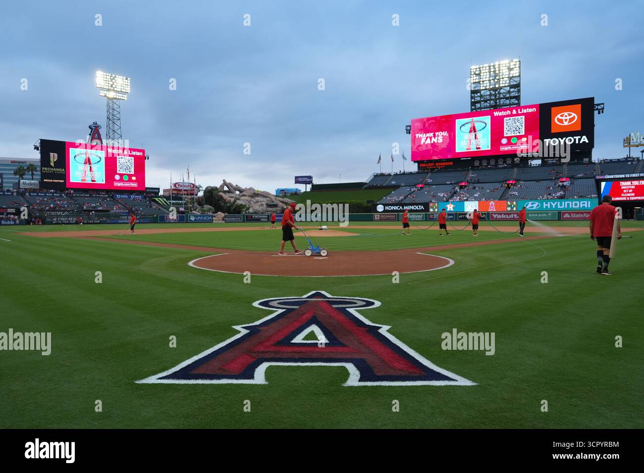 The grounds crew prepares the field before a baseball game between the ...