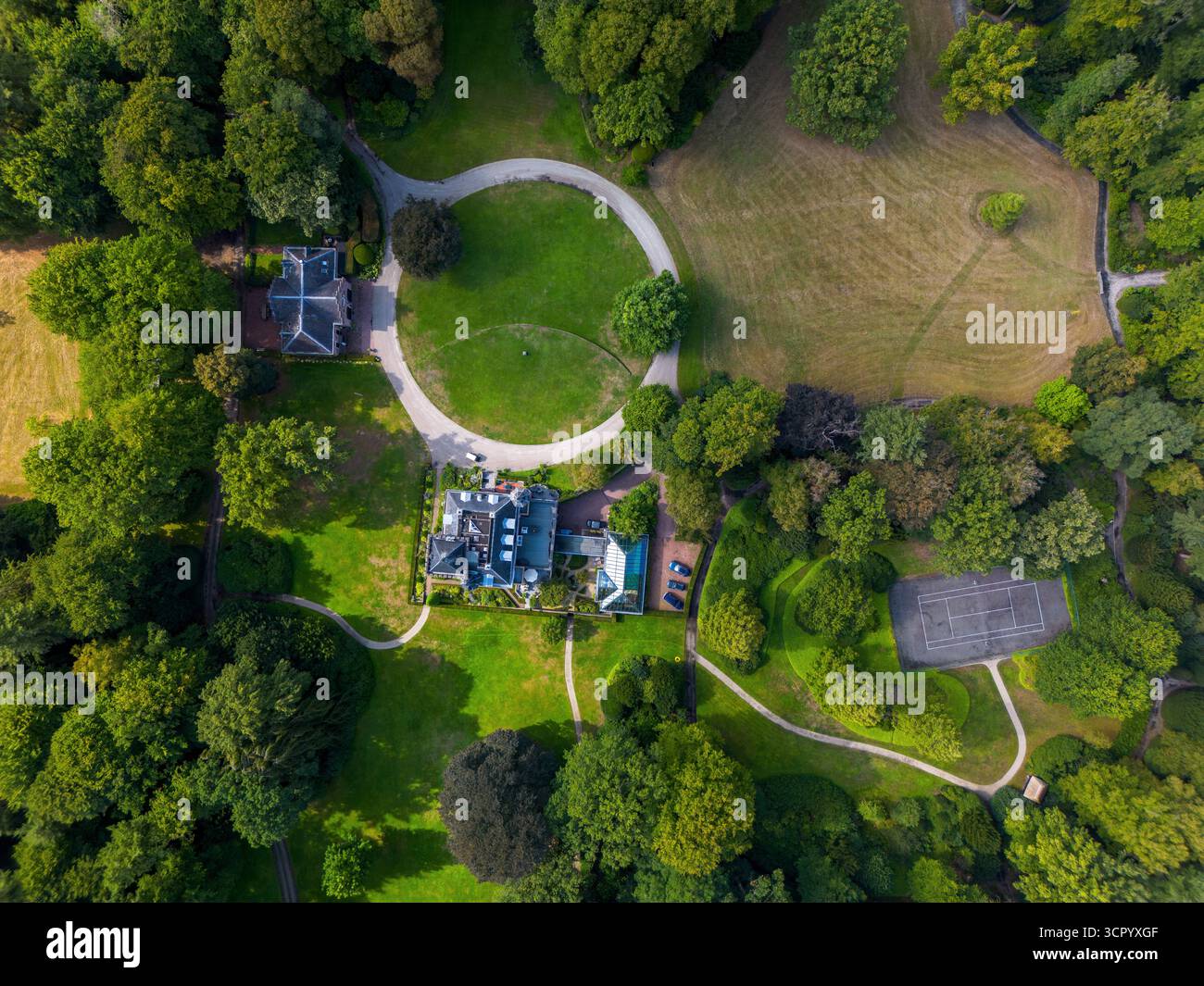 Aerial view of forested estate with central mansion, swimming pool ...
