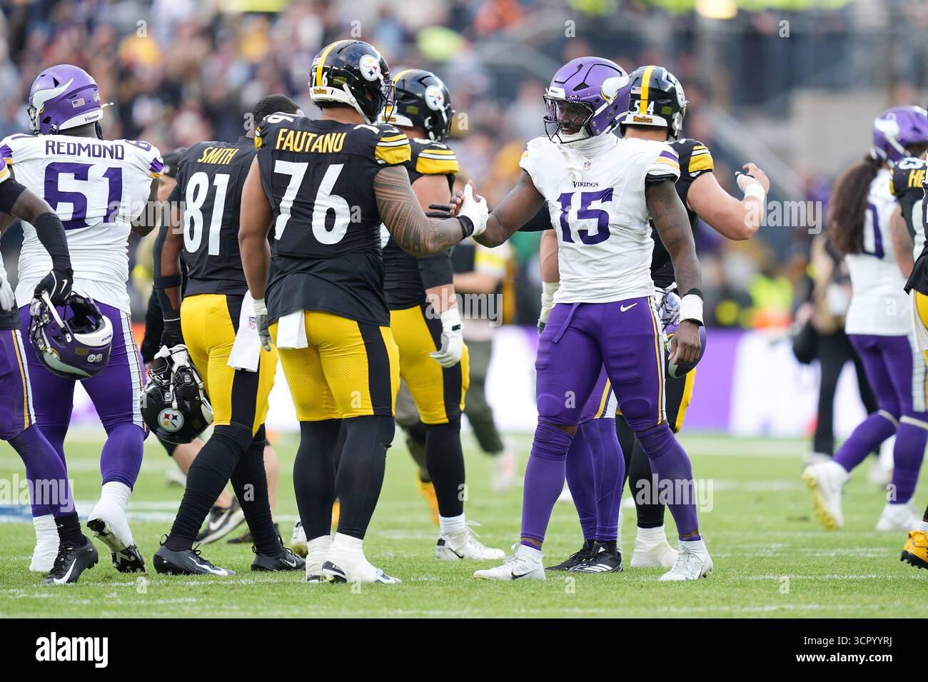 Pittsburgh Steelers' Troy Fautanu (left) shakes hands with Minnesota ...