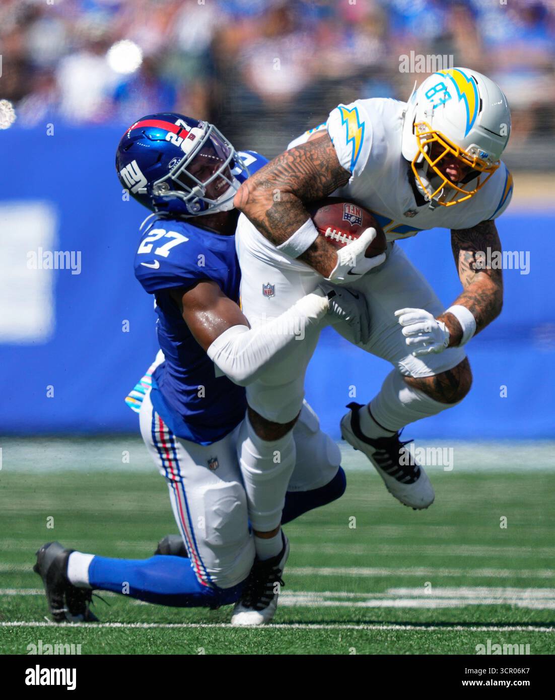 New York Giants safety Tyler Nubin (27) tackles Los Angeles Chargers ...