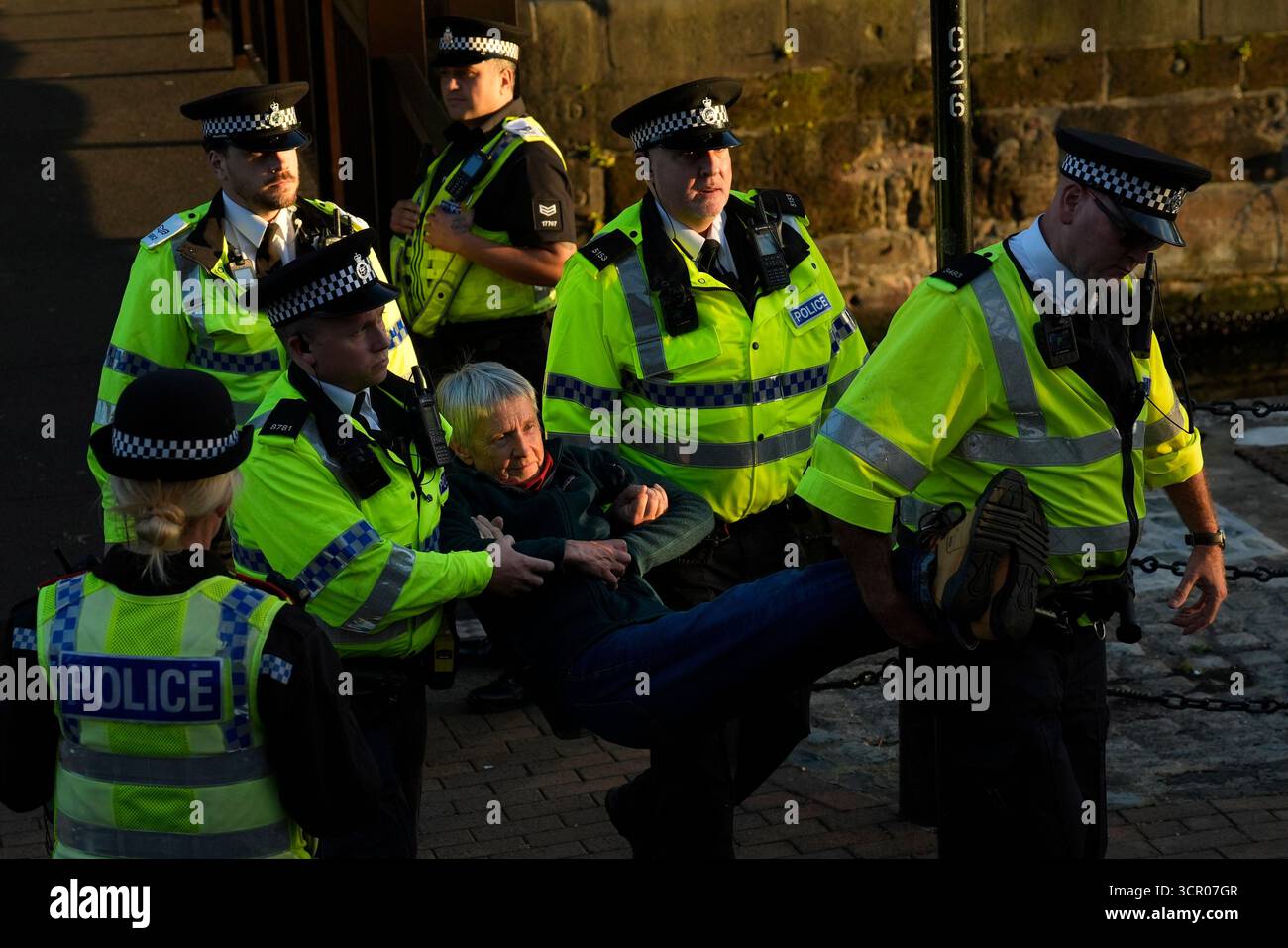 A protestor is carried away by police at a Palestine Action ...