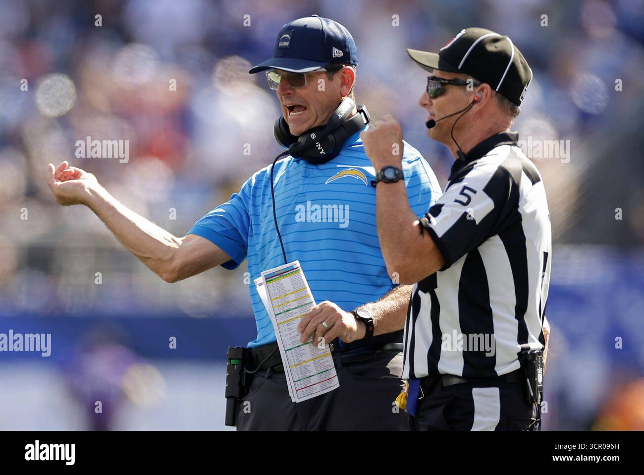 Los Angeles Chargers head coach Jim Harbaugh talks with side judge Jim ...