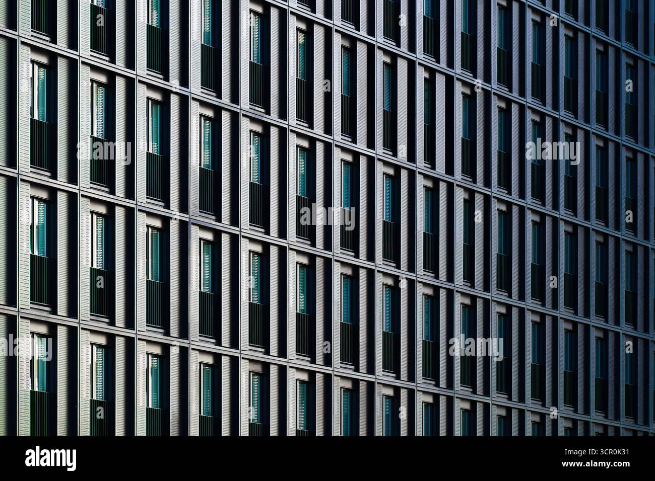 Modern residential building facade with repeating balconies and ...