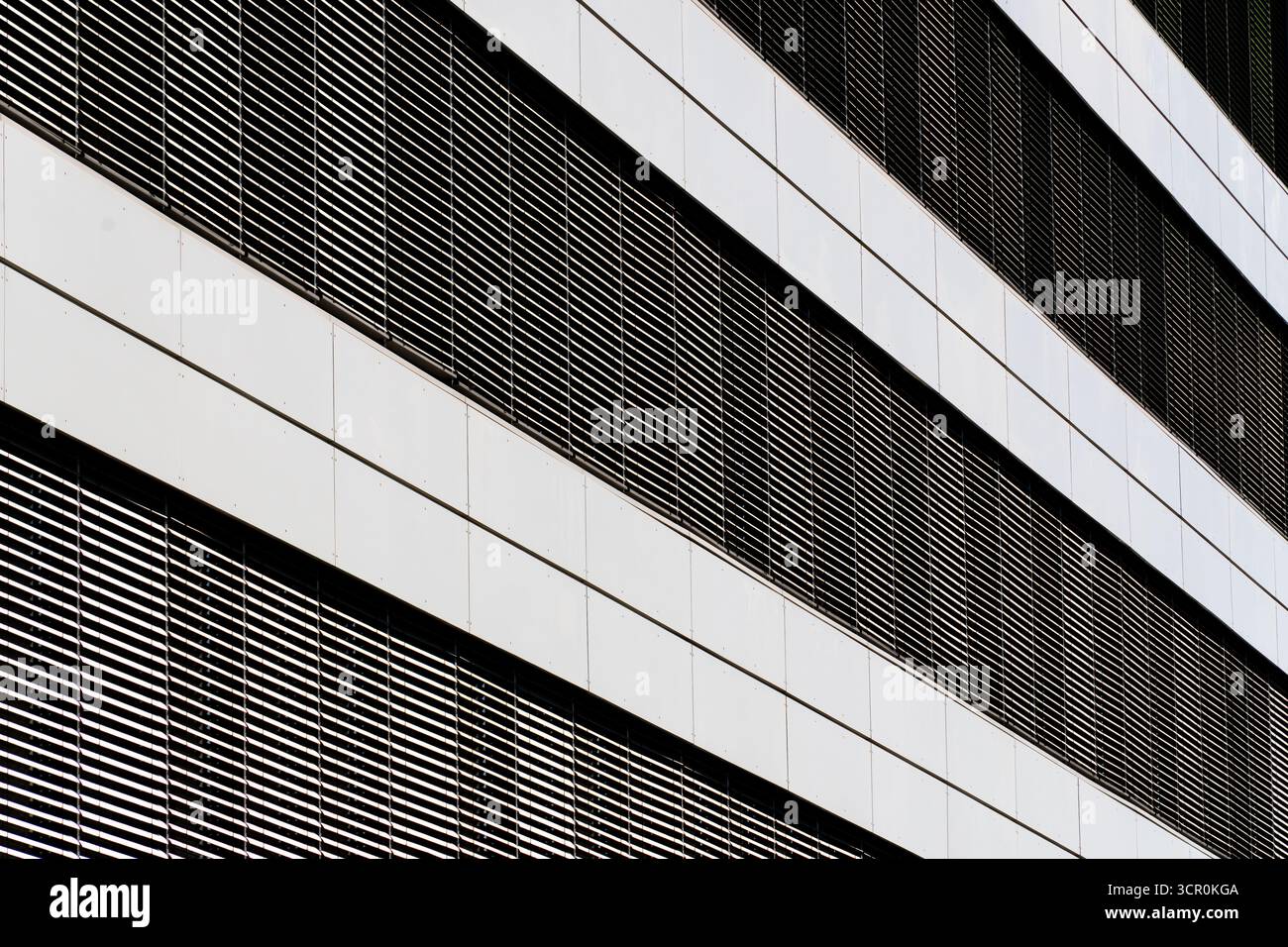 Modern architectural facade with horizontal metal louvers and ...