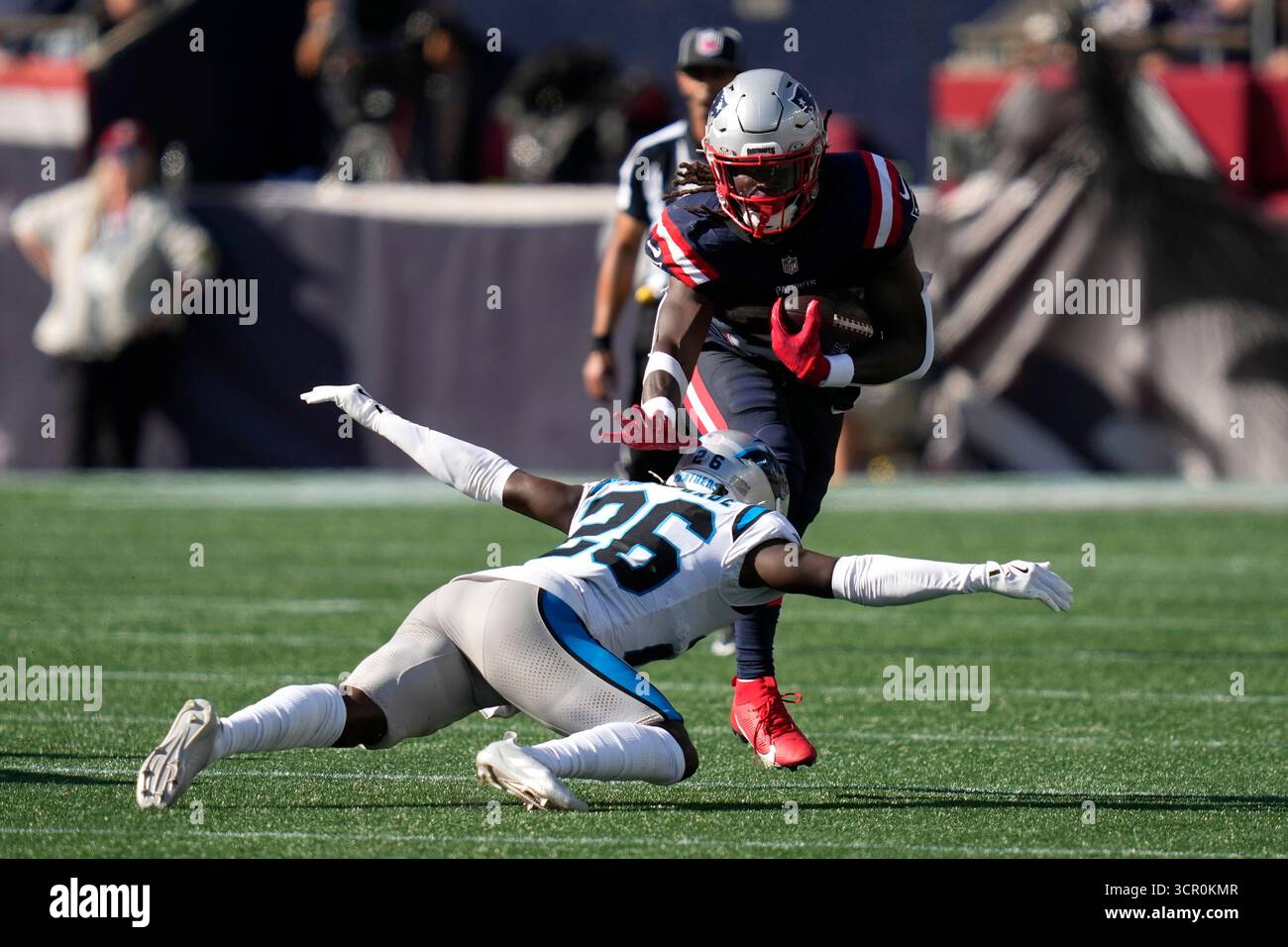New England Patriots running back Rhamondre Stevenson, top, runs ...