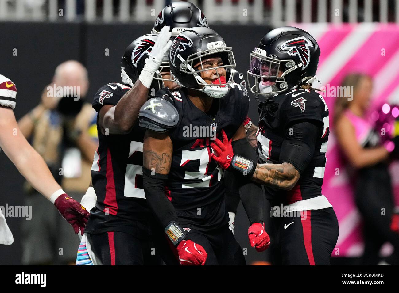 Atlanta Falcons safety Xavier Watts, center, celebrates his ...