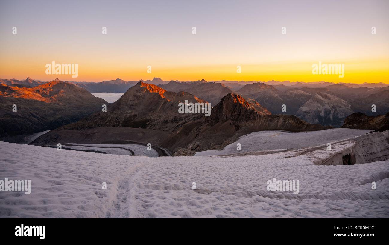 Early morning sunlight casts a warm glow over Pers Glacier in the ...