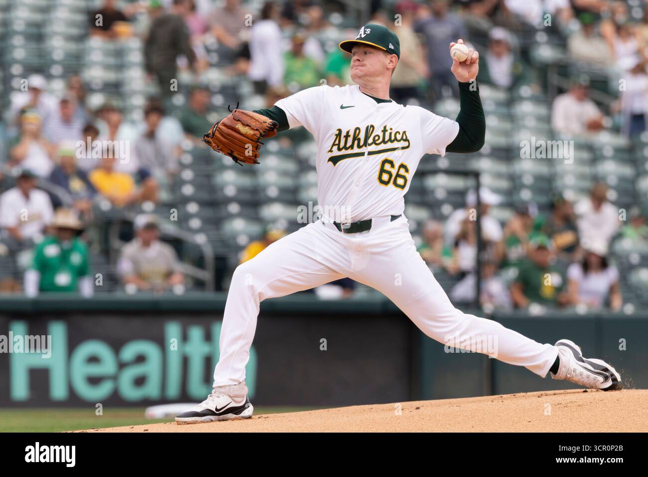 Athletics pitcher Brady Basso throws to the Kansas City Royals during ...