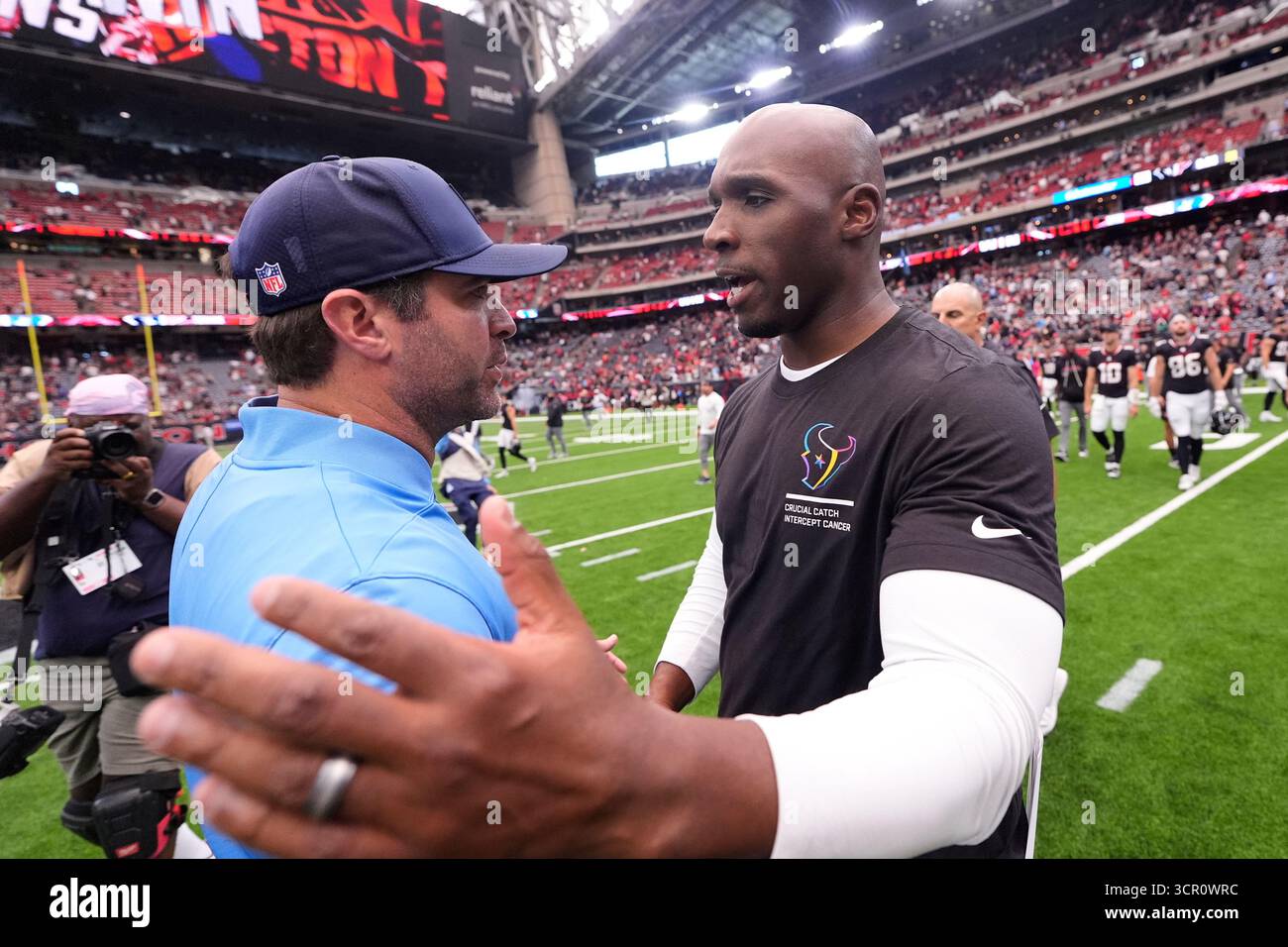 Tennessee Titans head coach Brian Callahan, left, meets Houston Texans head coach DeMeco Ryans ...