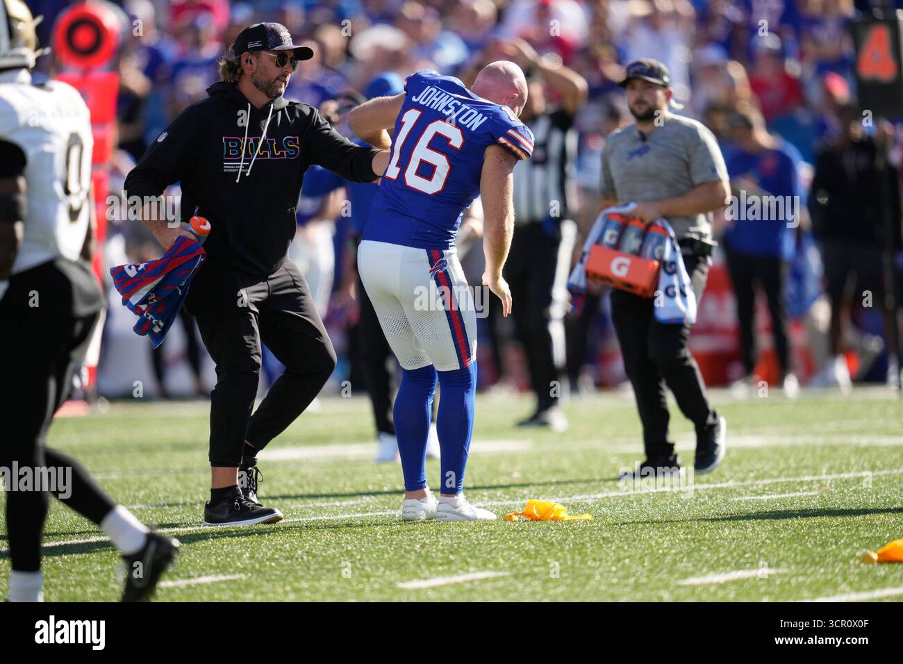 Buffalo Bills punter Cameron Johnston (16) is helped after being hit in ...