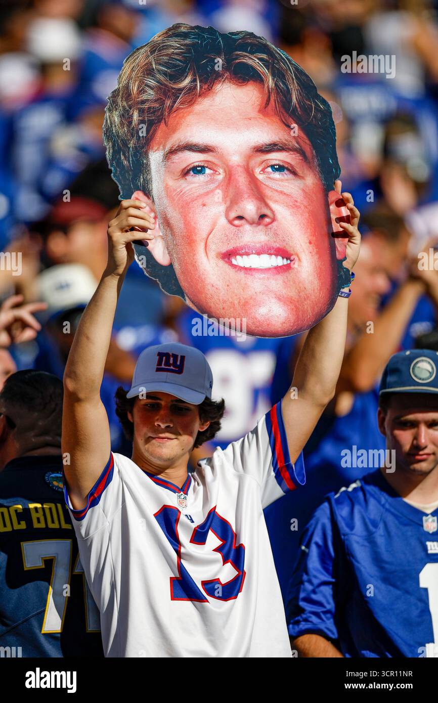 A New York Giants fan holds up a poster of New York Giants quarterback ...