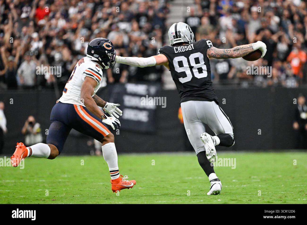 Las Vegas Raiders defensive end Maxx Crosby (98) returns an interception against Chicago Bears ...