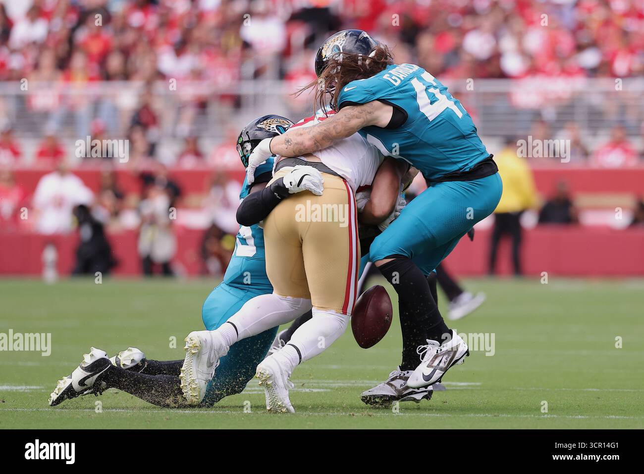 San Francisco 49ers tight end Luke Farrell, middle, fumbles the ball ...