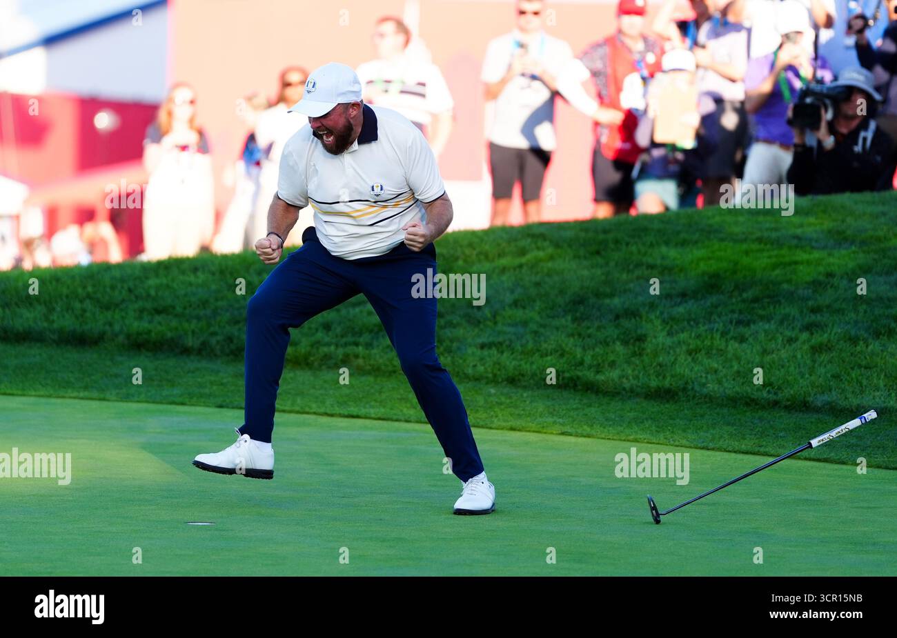 Shane Lowry celebrates a putt on the 18th green to retain the Ryder Cup ...