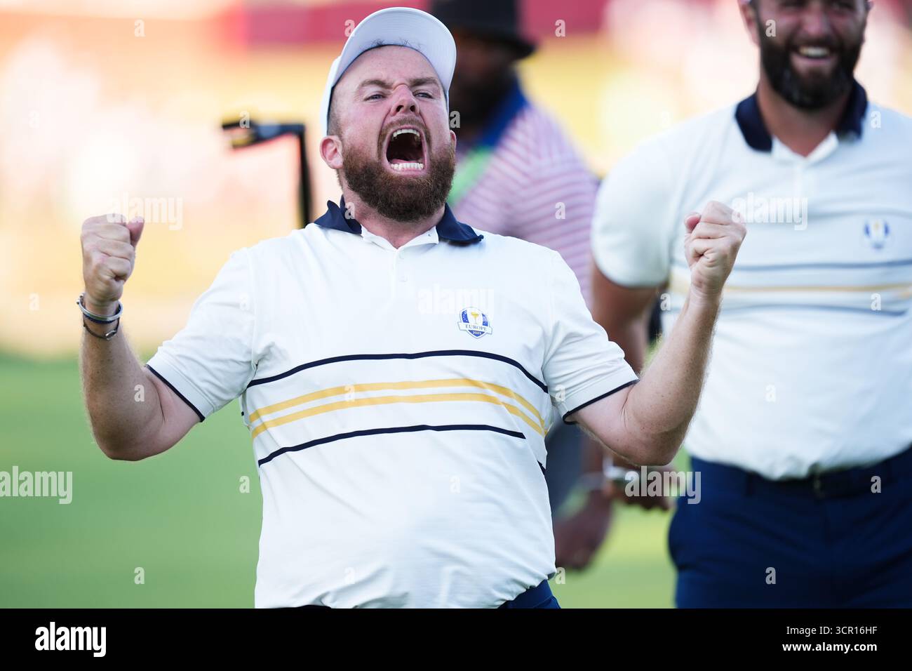 Shane Lowry celebrates a putt on the 18th green to retain the Ryder Cup ...