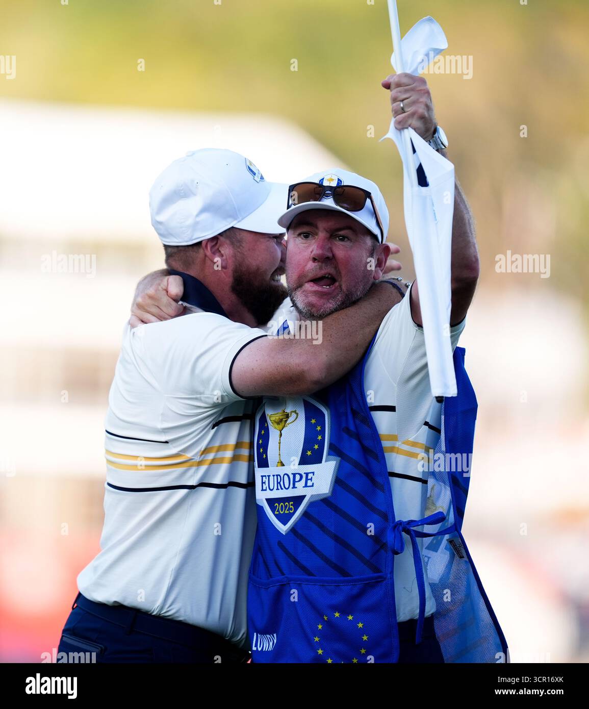 Shane Lowry celebrates a putt on the 18th green with his caddie Darren ...