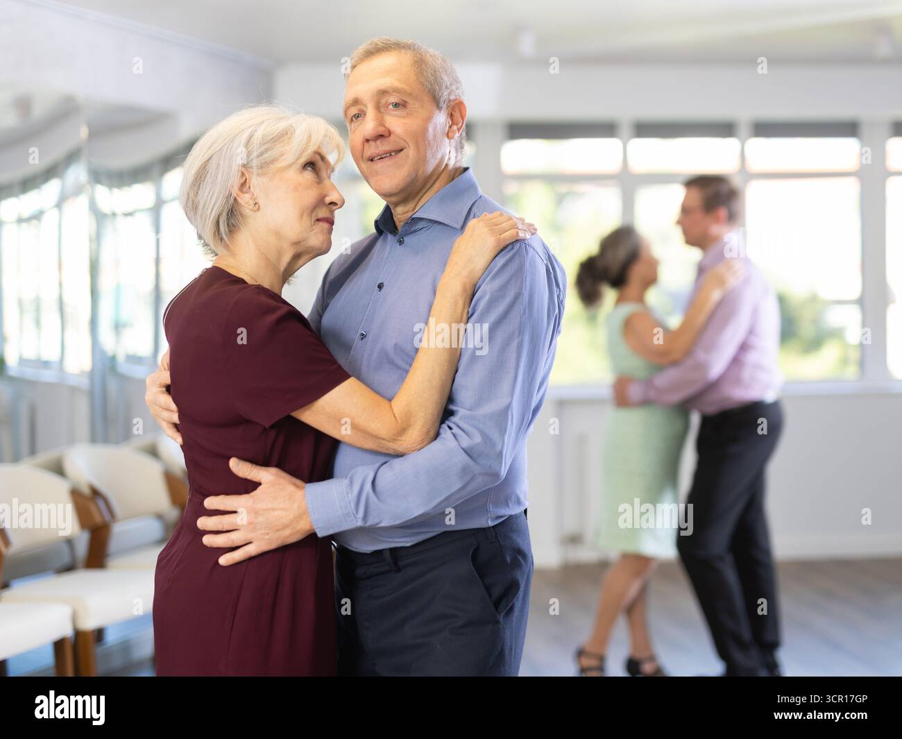 Elderly woman is dancing slow unhurried dance in hugs arms of her ...