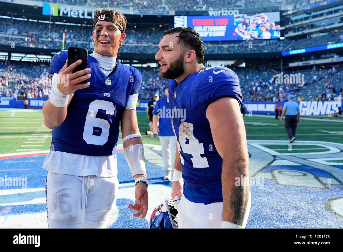 New York Giants quarterback Jaxson Dart (6) and running back Cam Skattebo (44) talk on the field ...