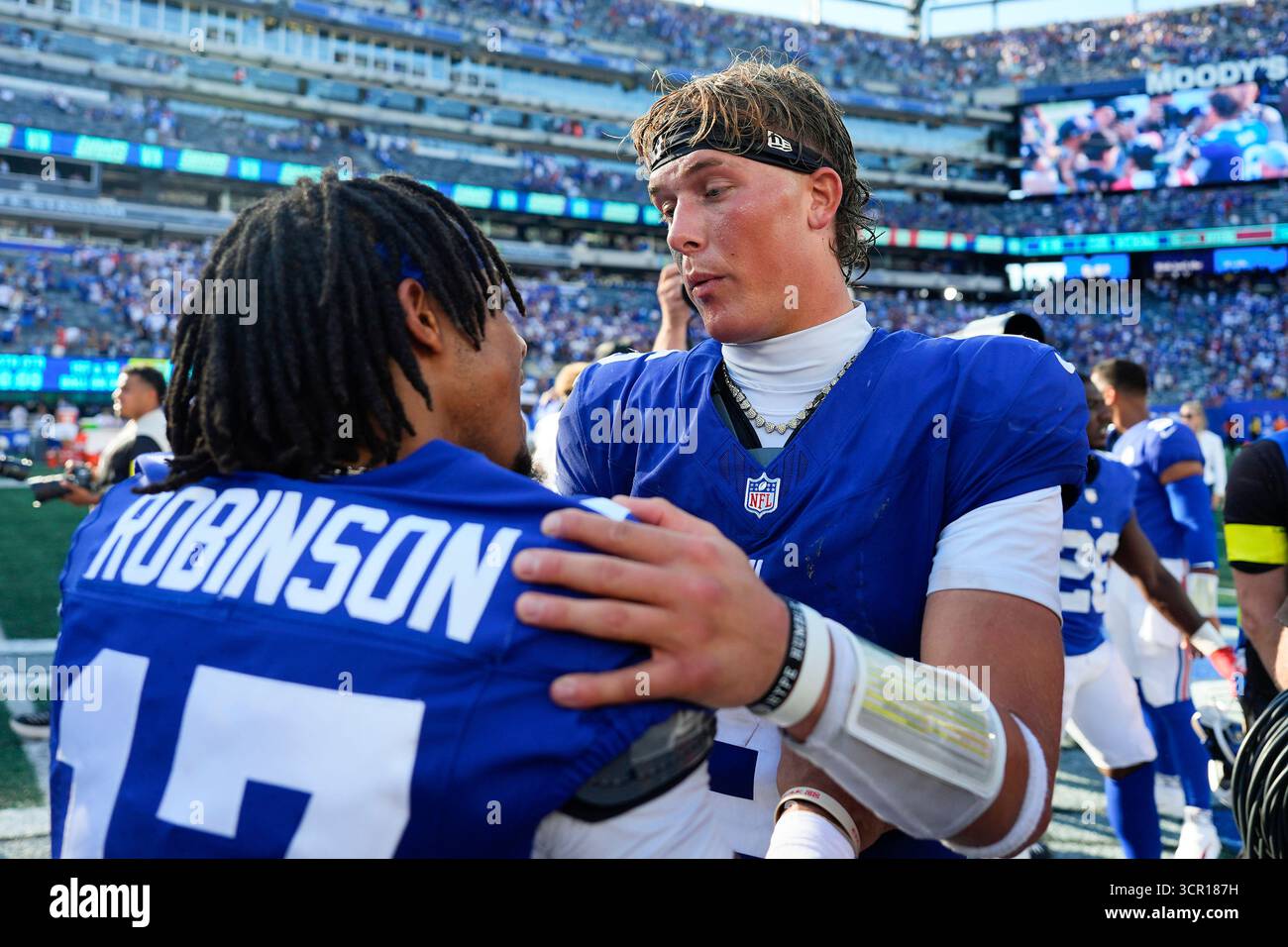 New York Giants quarterback Jaxson Dart, right, talks with wide ...