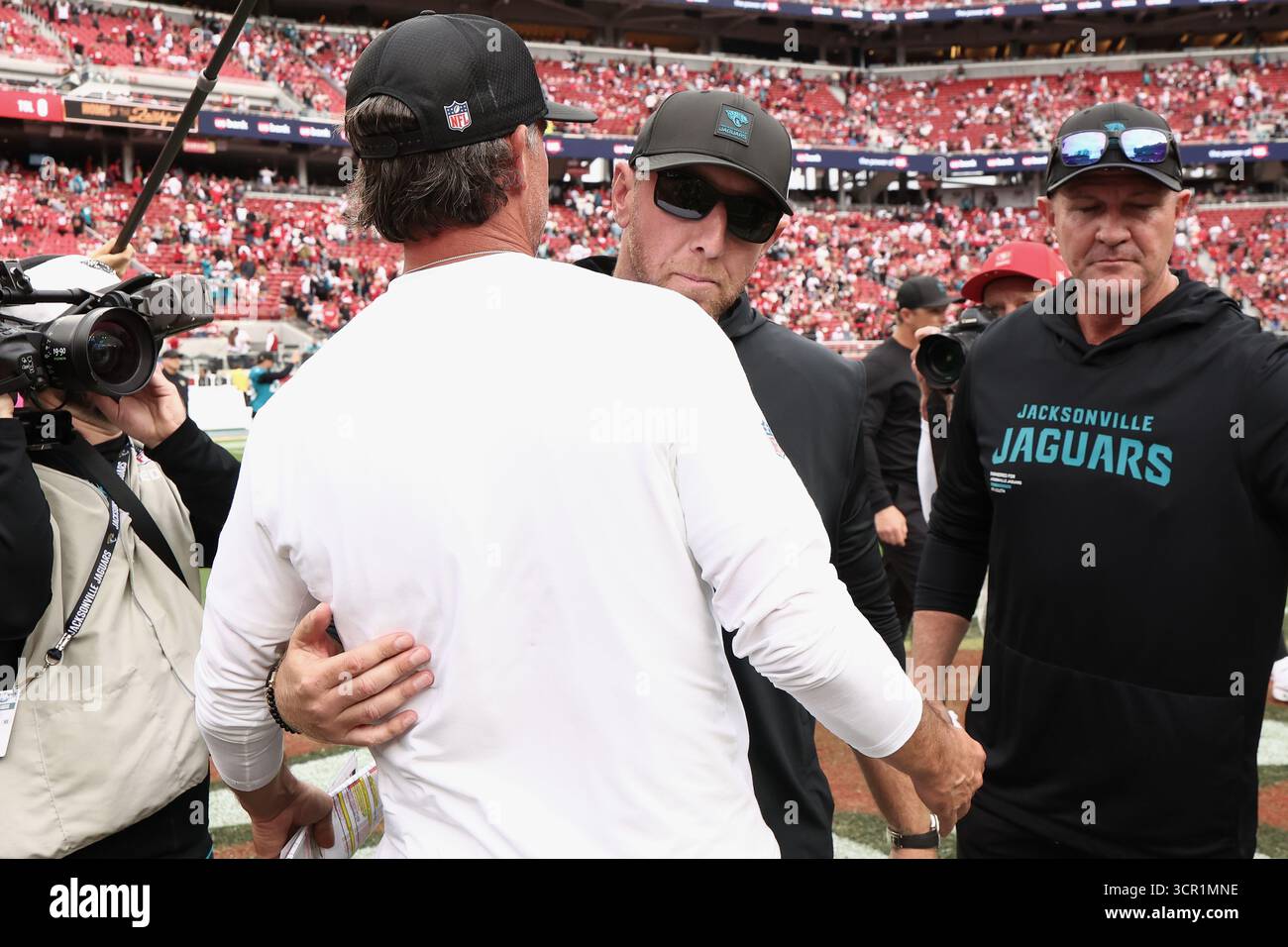 San Francisco 49ers head coach Kyle Shanahan, left, greets Jacksonville ...